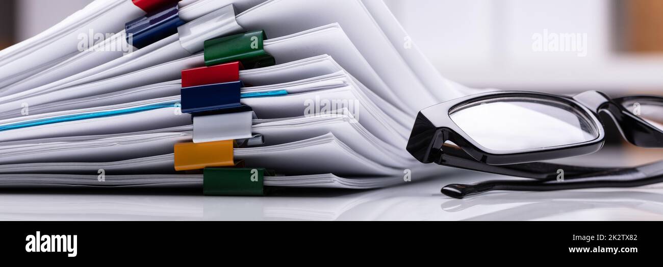Stacked Documents And Eyeglasses Stock Photo - Alamy