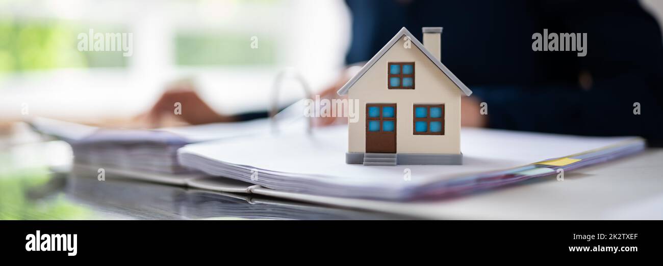 Businesswoman's hand calculating invoice Stock Photo - Alamy