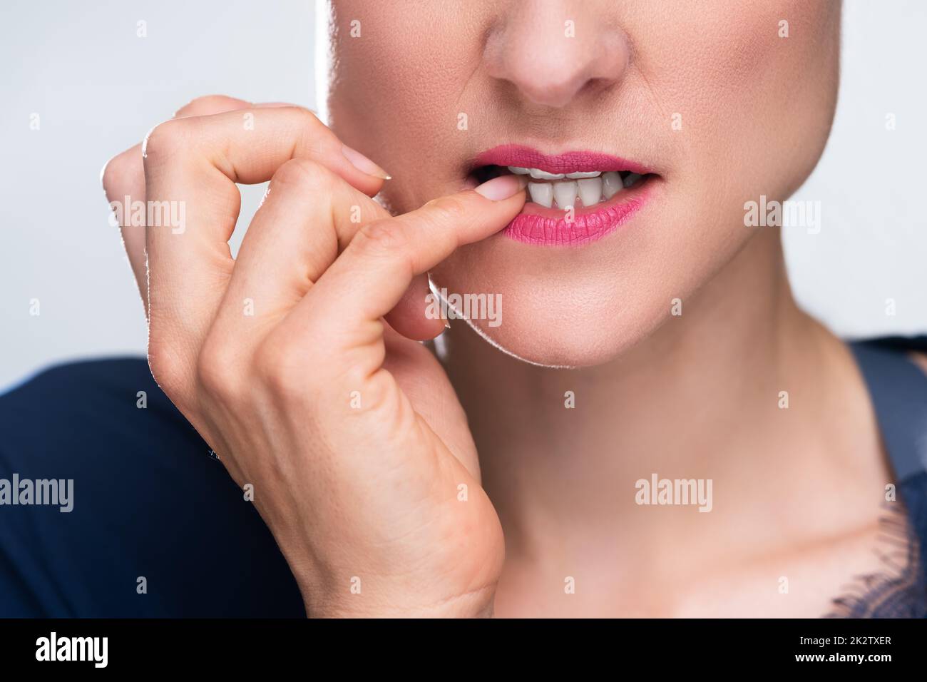 Businesswoman Biting Her Fingernail Stock Photo - Alamy