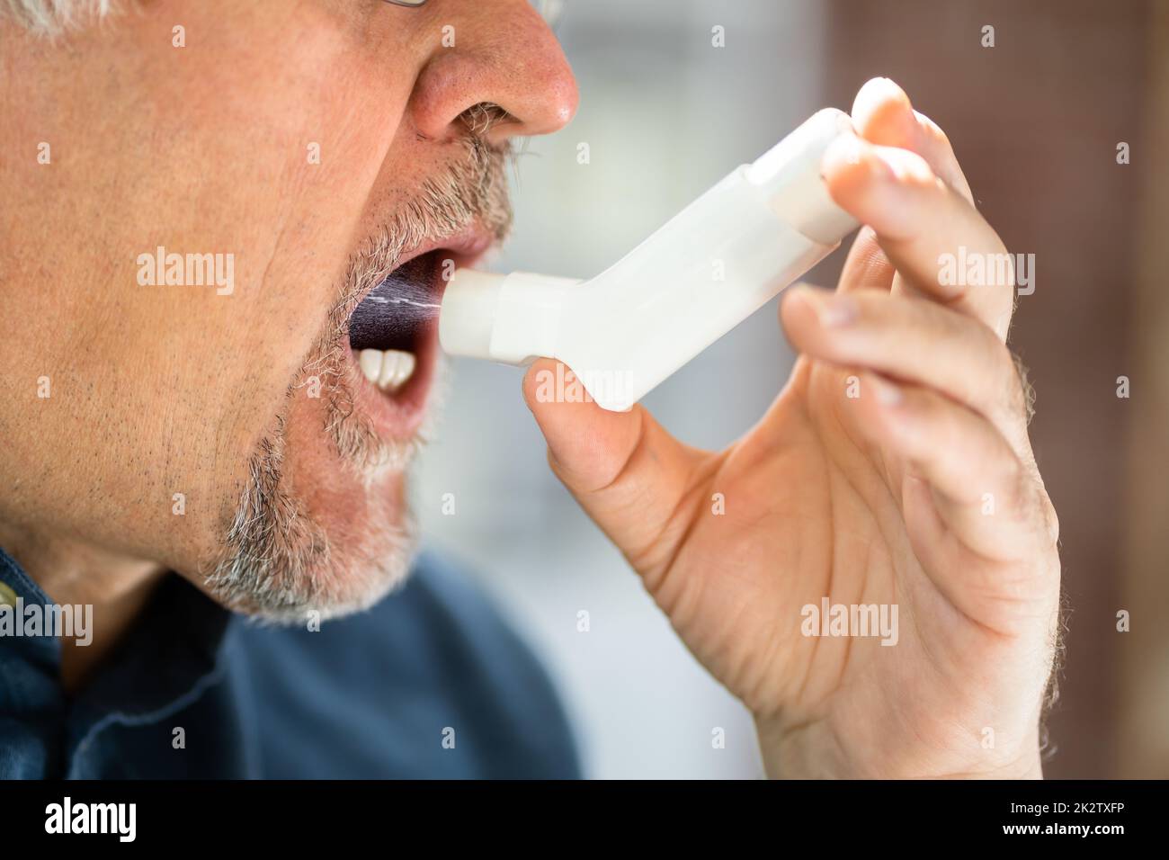 Man Using Asthma Inhaler Stock Photo - Alamy