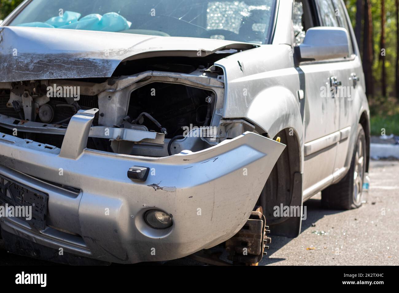 Broken headlights as a result of a collision. Broken gray car after an ...