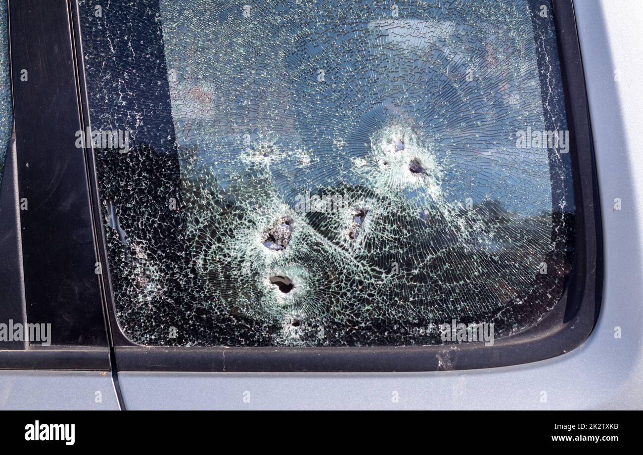 Car riddled with bullets. War of Russia against Ukraine. A car of ...