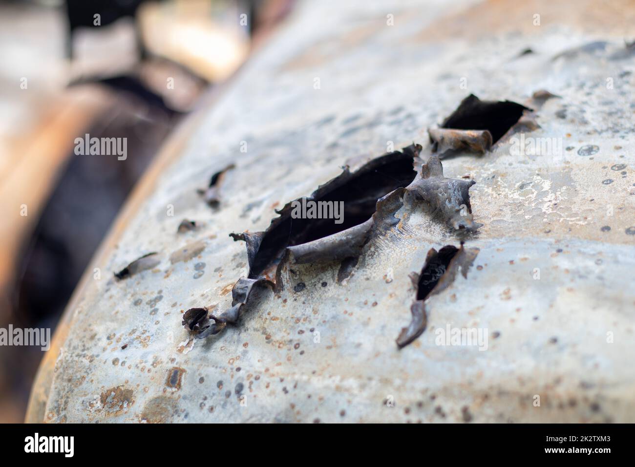 Burnt car body riddled with bullets. Russia's war against Ukraine. Shot ...
