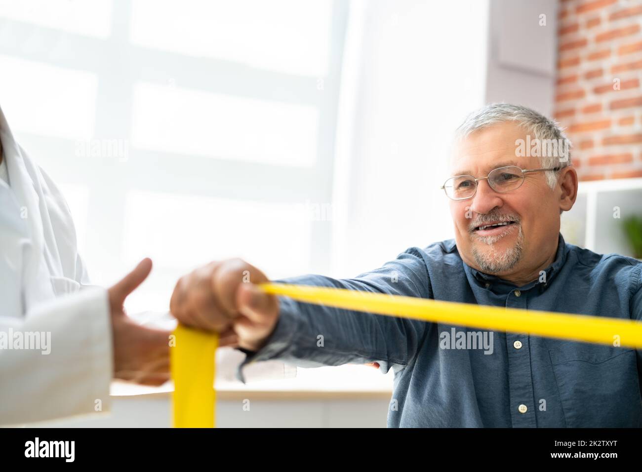 Male physiotherapist doing physical therapy hi-res stock photography ...