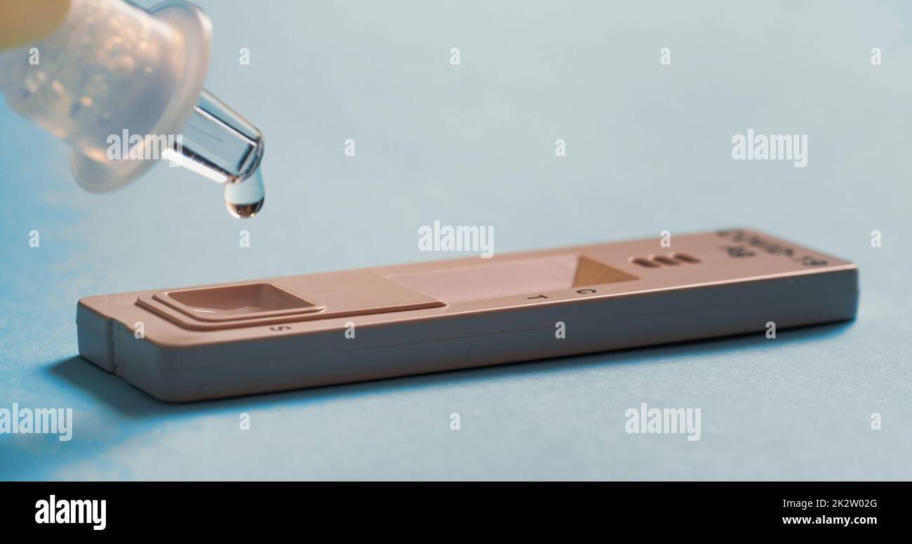 Adding drops to the details of the Covid-19 Antigen Test Stock Photo ...