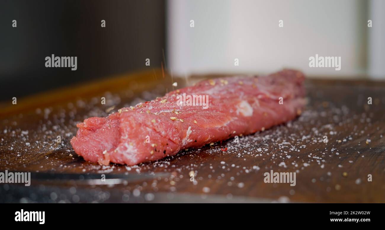 Seasoning Raw Meat on Preparation Table. Chef preparing Meat Stock ...