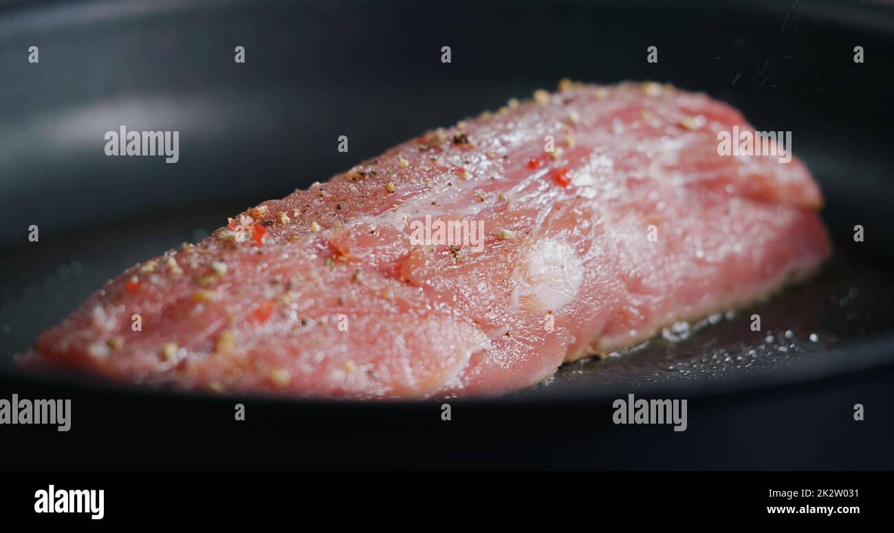 Raw Pork Meat Seasoned is Frying in Hot Pan Stock Photo - Alamy