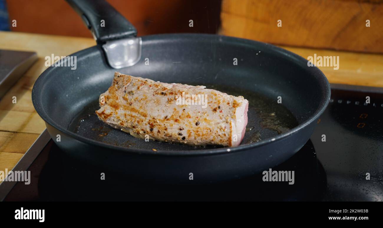 Pork Meat Frying in Hot Pan. Close Up. Seasoning with Falling Herbs on ...
