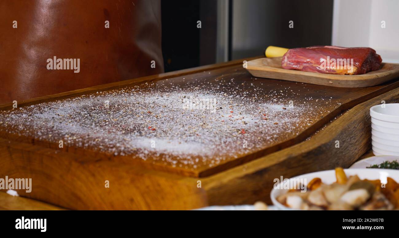Strewing Salt and Pepper on Wood Chipper for Fresh Raw Beef Angus Meat ...