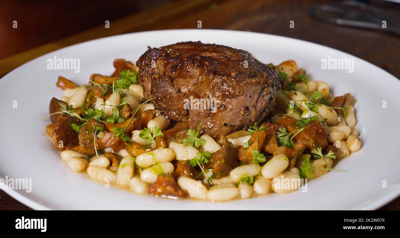 Professional chef cooking in kitchen. Male hands pouring delicious ...