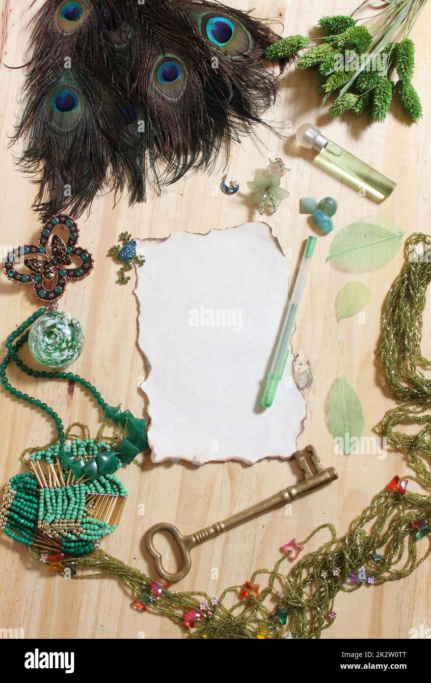 Vintage Burned Paper and Antique Key Surrounded By Green Jewelry and ...