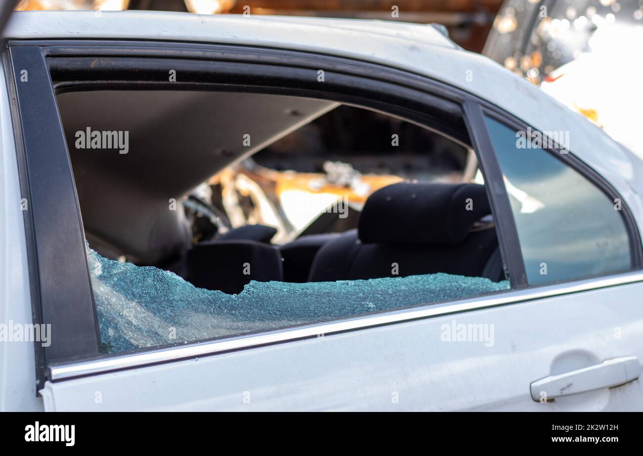 Criminal incident. Breaking into a car parked on the street. Broken ...