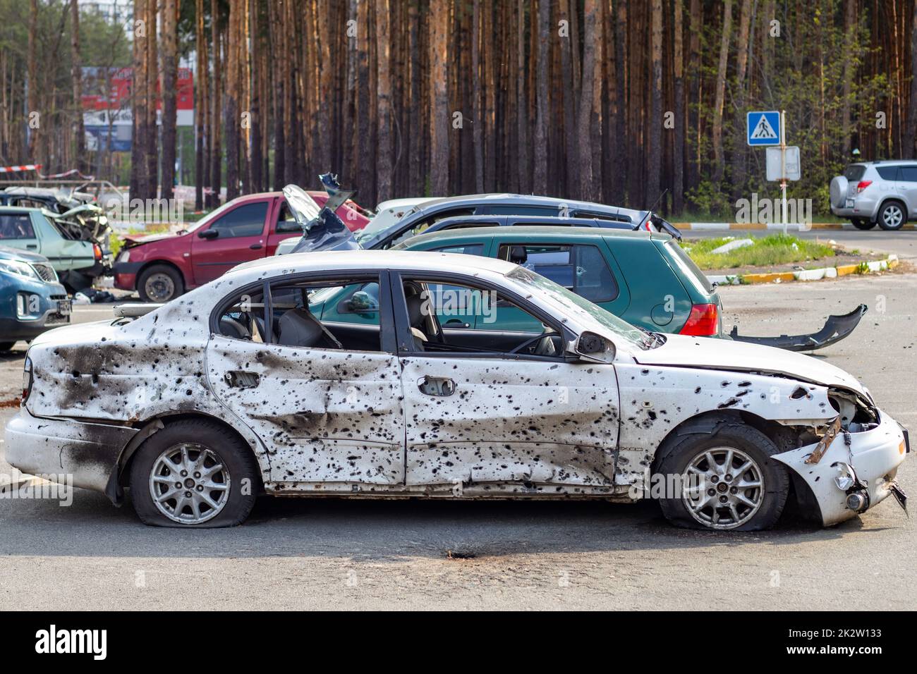 A car destroyed by shrapnel from a rocket that exploded nearby ...