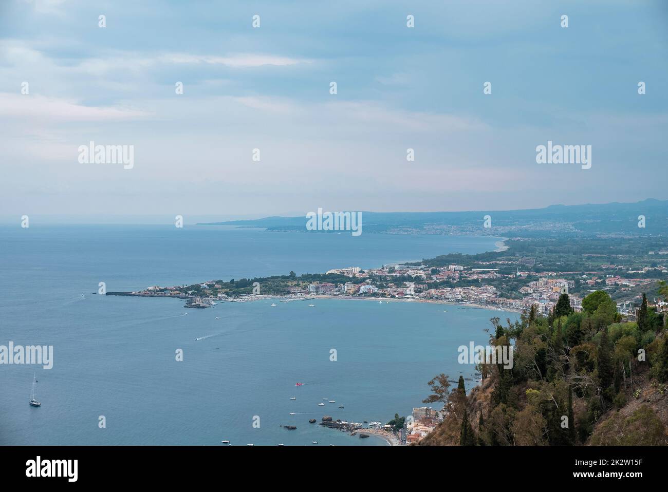Beautiful scenery of landscape by sea with cloudy sky in background ...