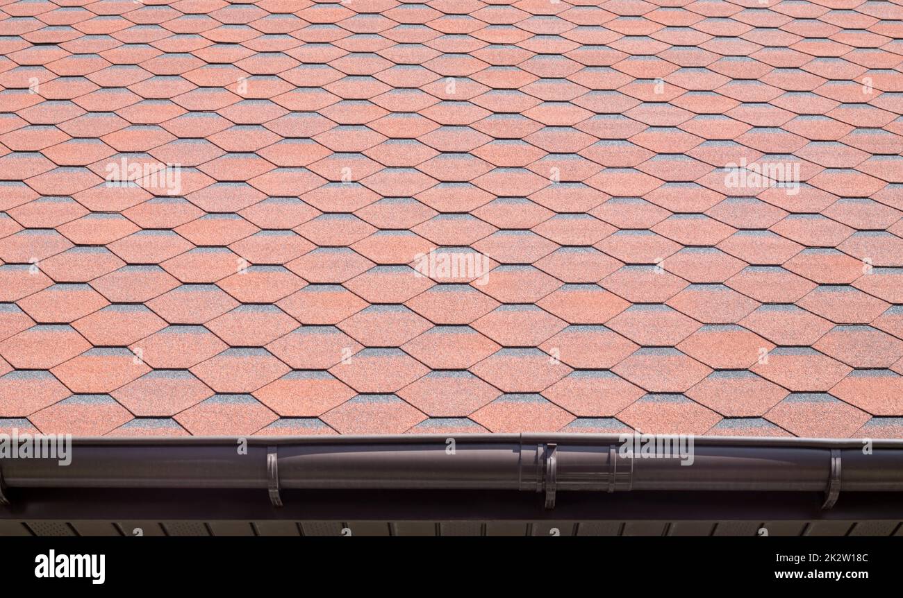 New roof with red shingles. Tiles on the roof of the house. Use to ...