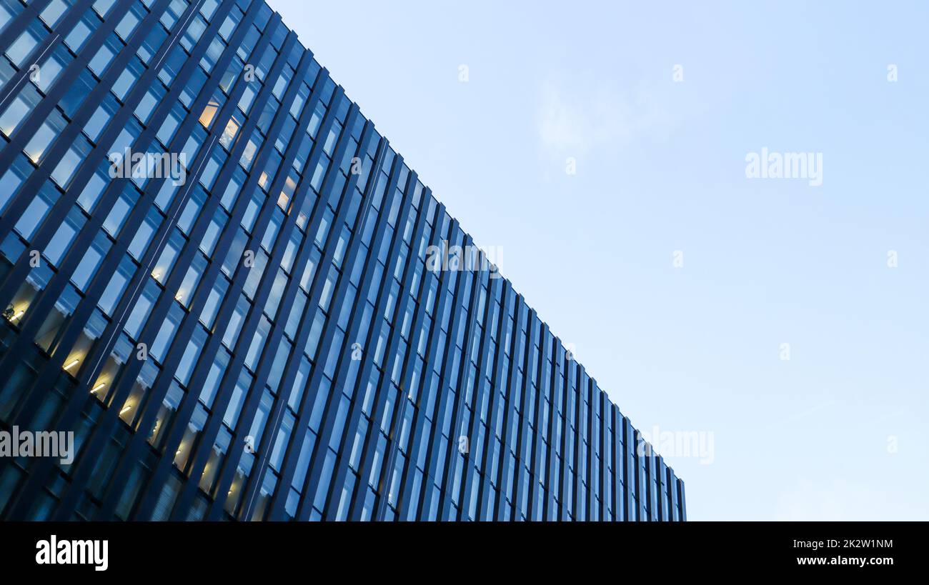 Modern high-rise building against the blue sky. Bottom view of a ...