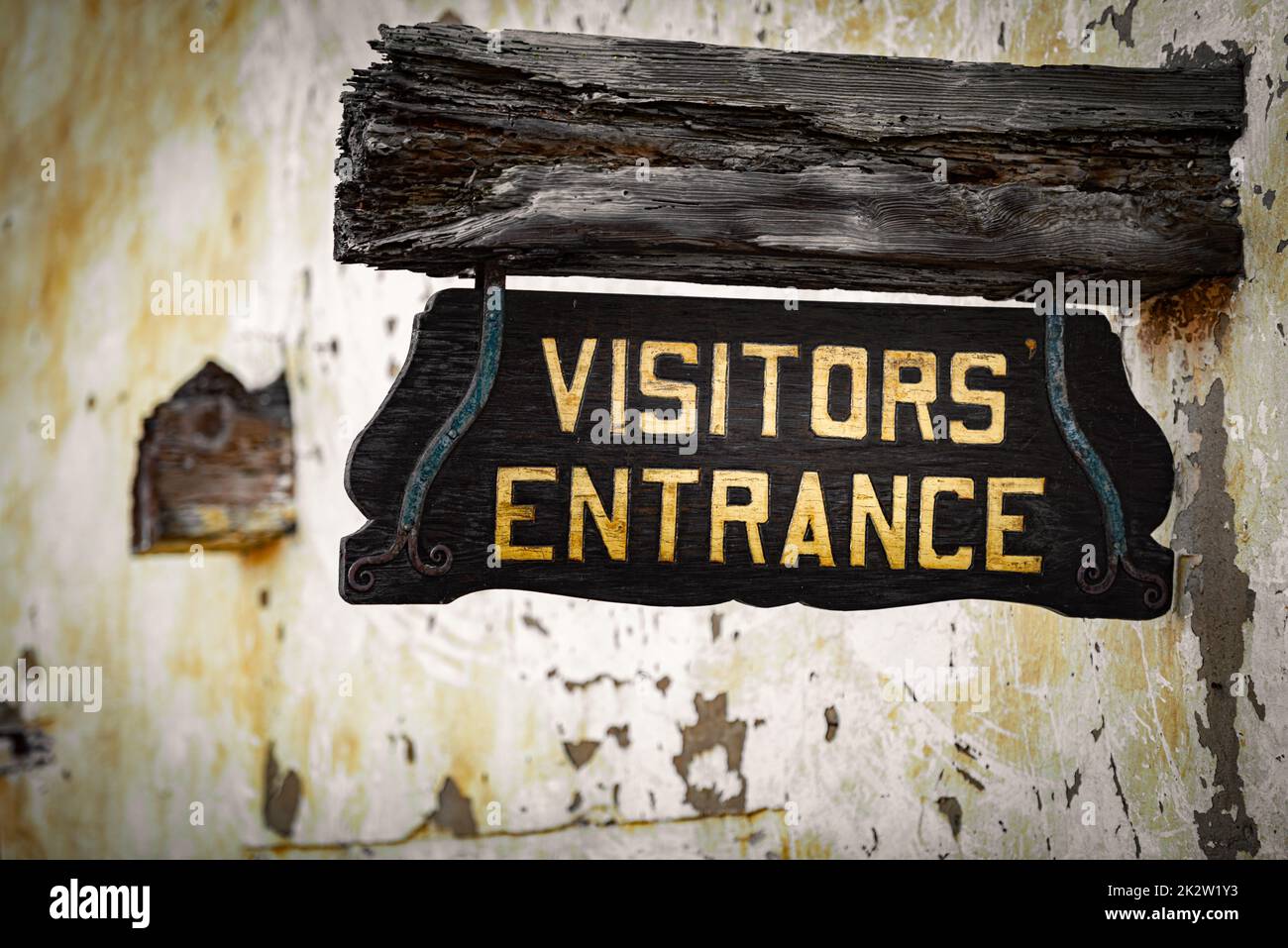 Old visitors entrance sign on wall Stock Photo - Alamy