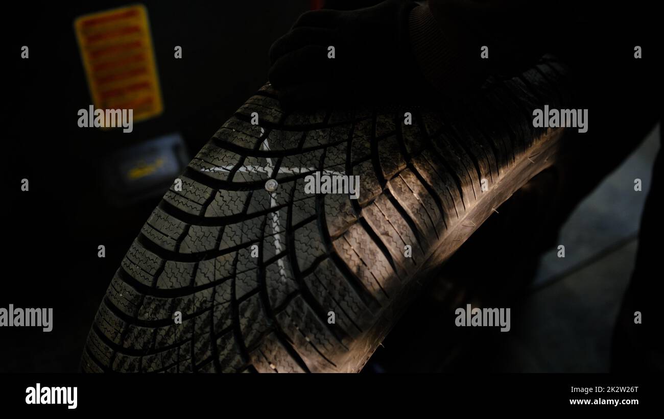 Repair service for wheel tire of car. Man show outside place of damage ...