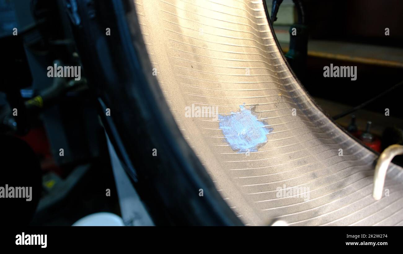 Repair service for wheel tire of car from small puncture. Close up view ...