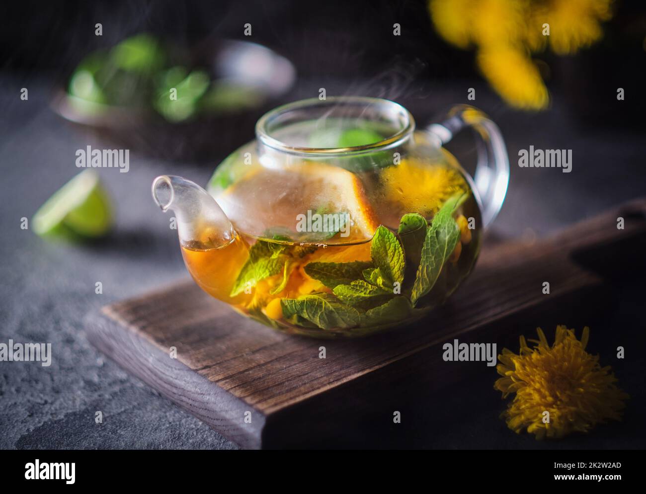 Glass teapot with fruit herbal tea. Advertising composition: tea with ...
