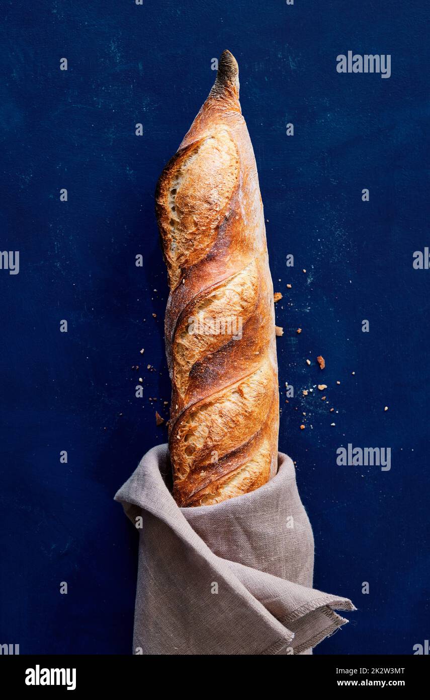 Freshly baked baguettes on a blue background Stock Photo - Alamy