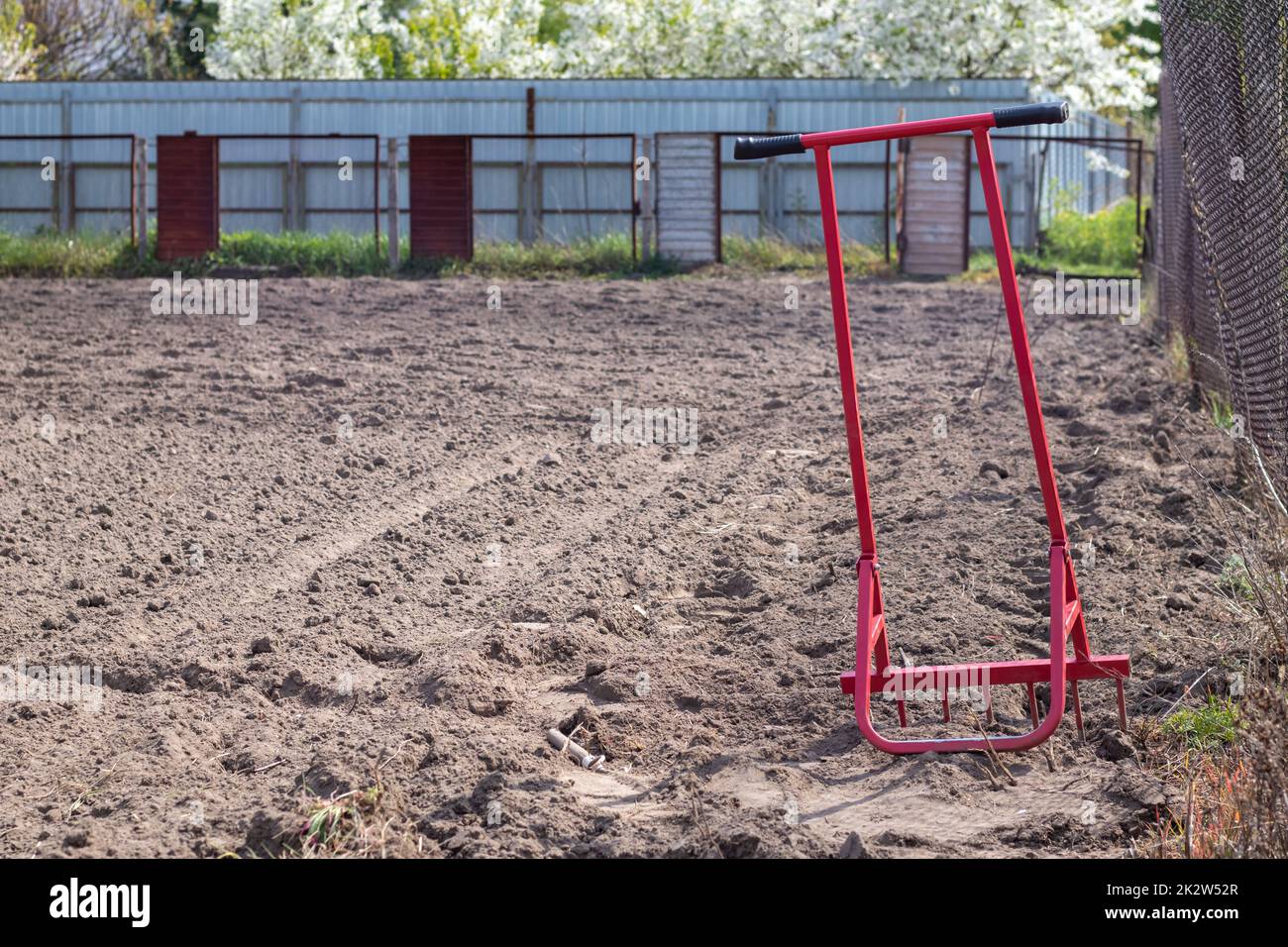 Red shovel in the form of a fork in the garden. Miracle shovel, handy ...
