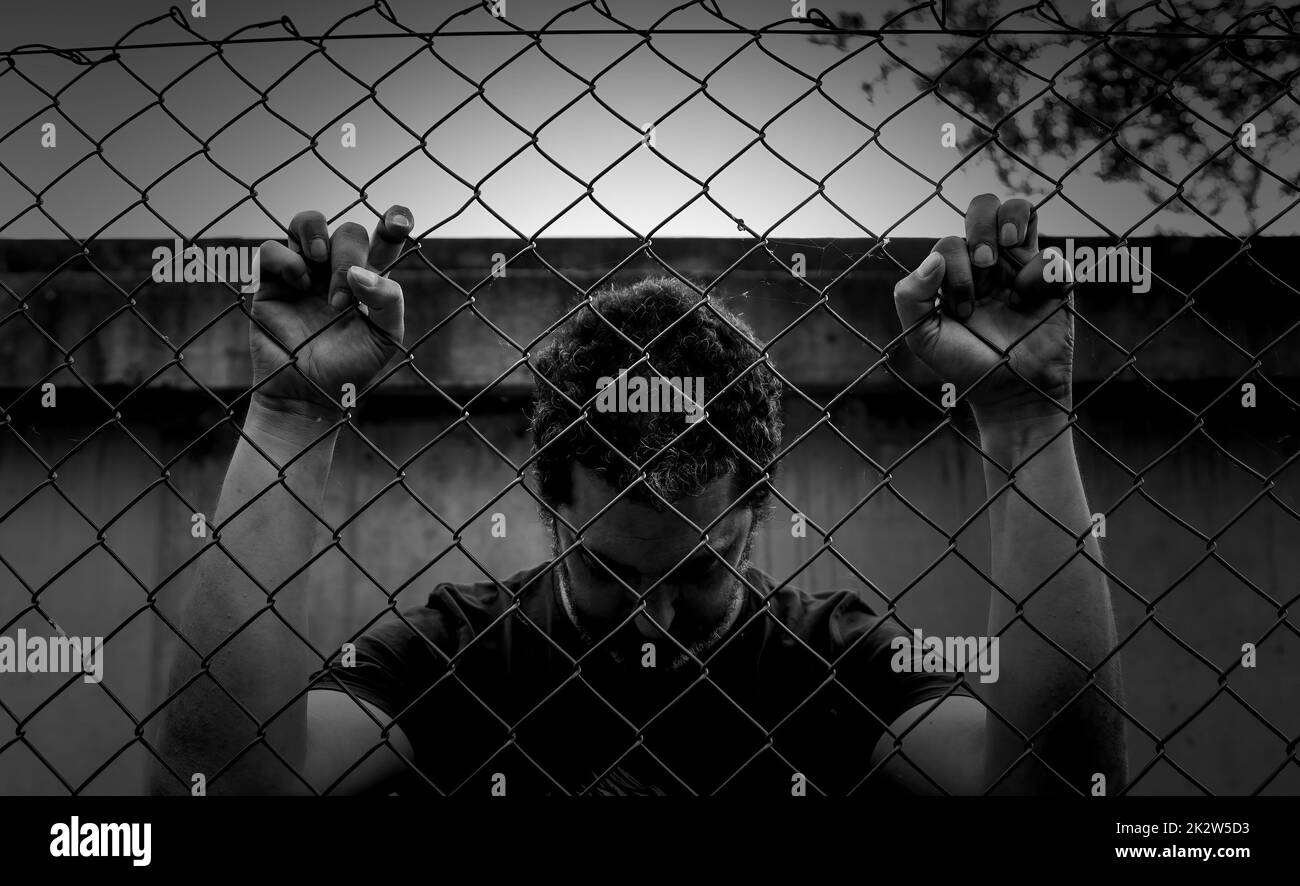 Hands on a fence Stock Photo - Alamy
