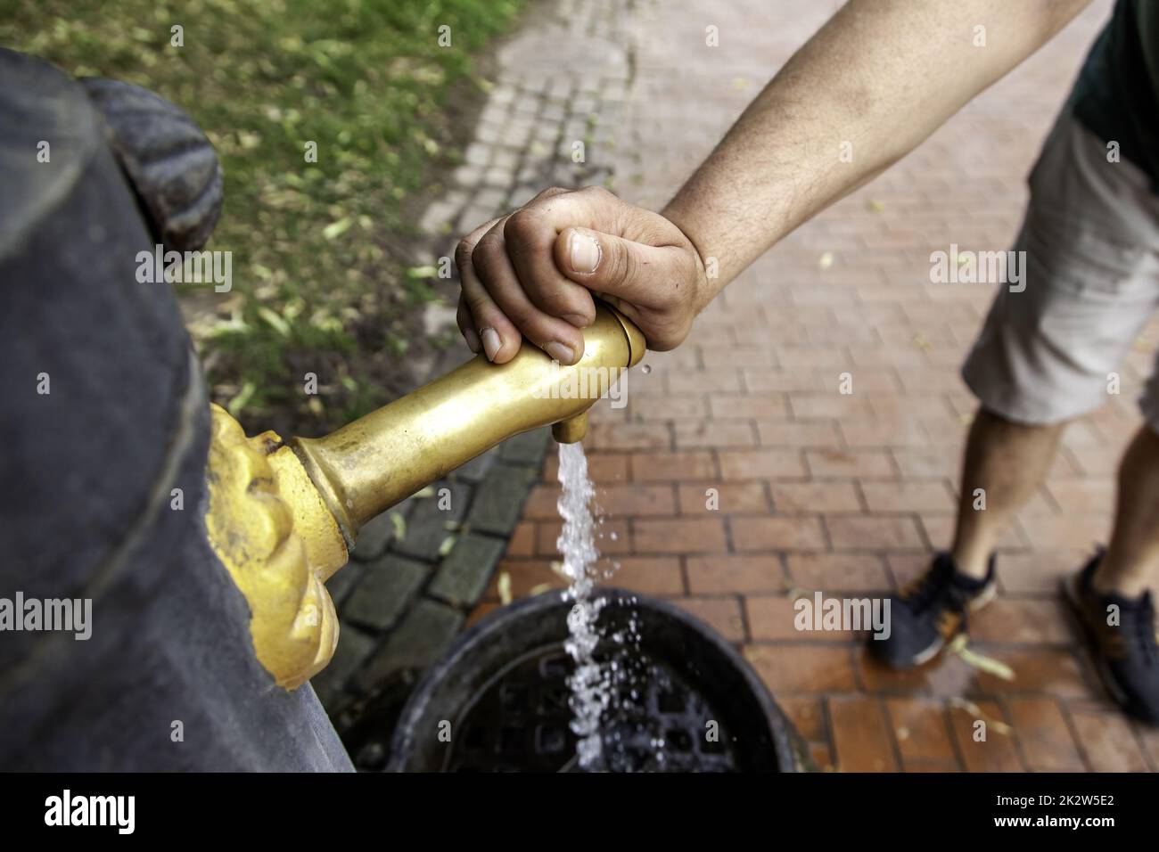 Hand in fountain with water Stock Photo - Alamy