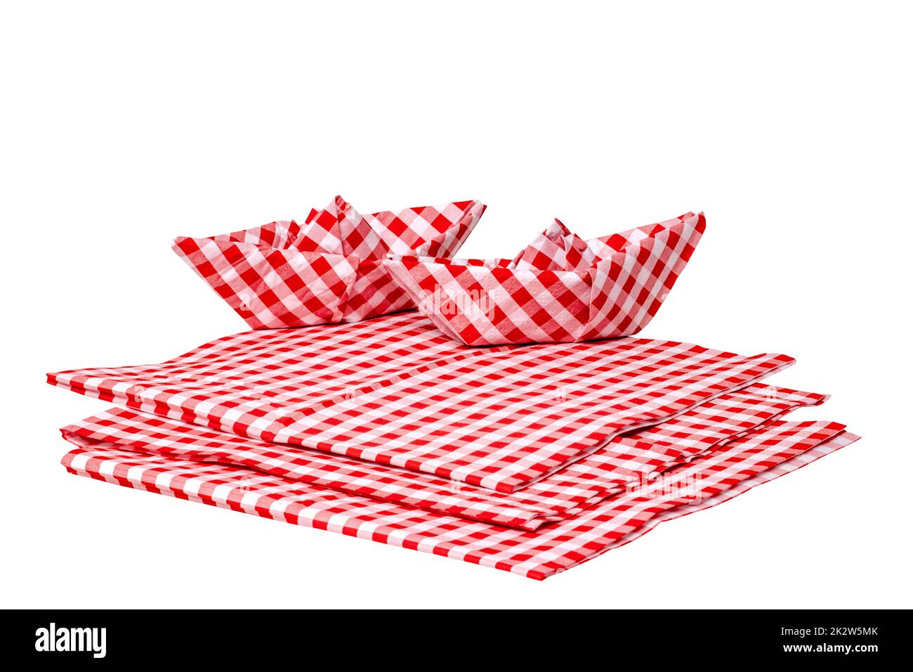 Closeup of a stack of red checked paper napkins and two folded paper ...