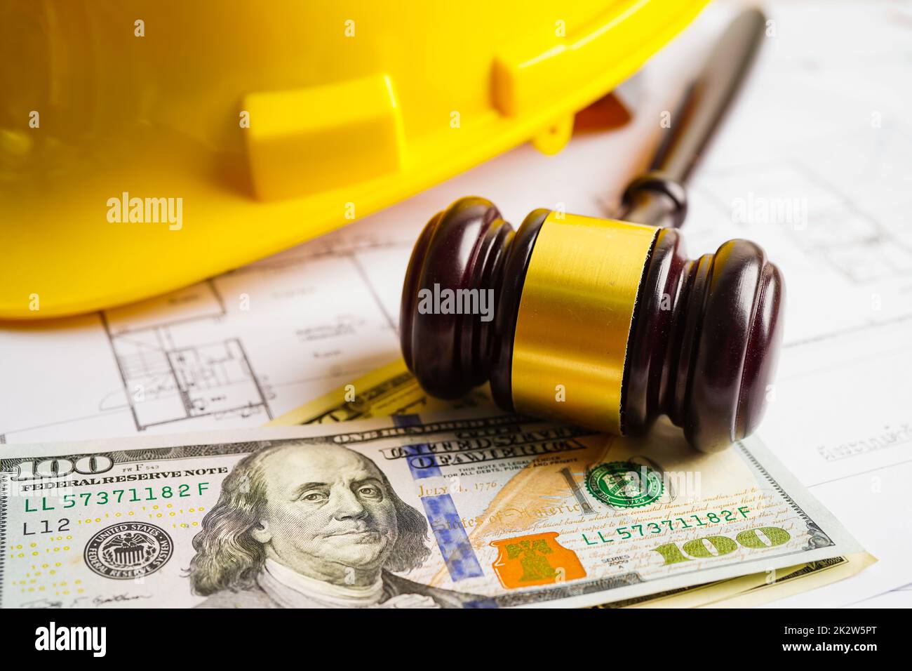 Gavel for judge lawyer with construction helmet and US dollar banknotes ...