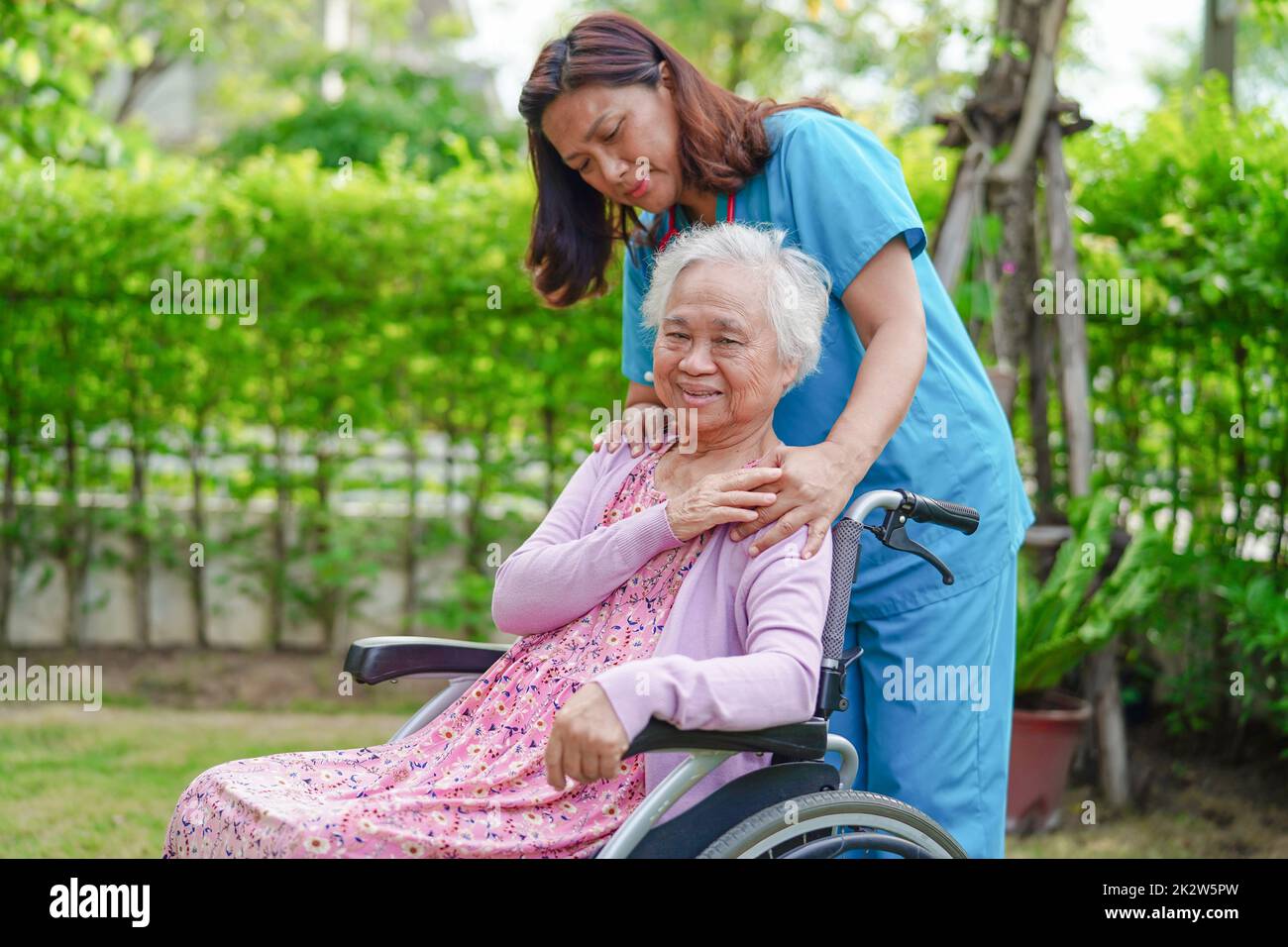 Caregiver help and support Asian senior or elderly old lady woman ...