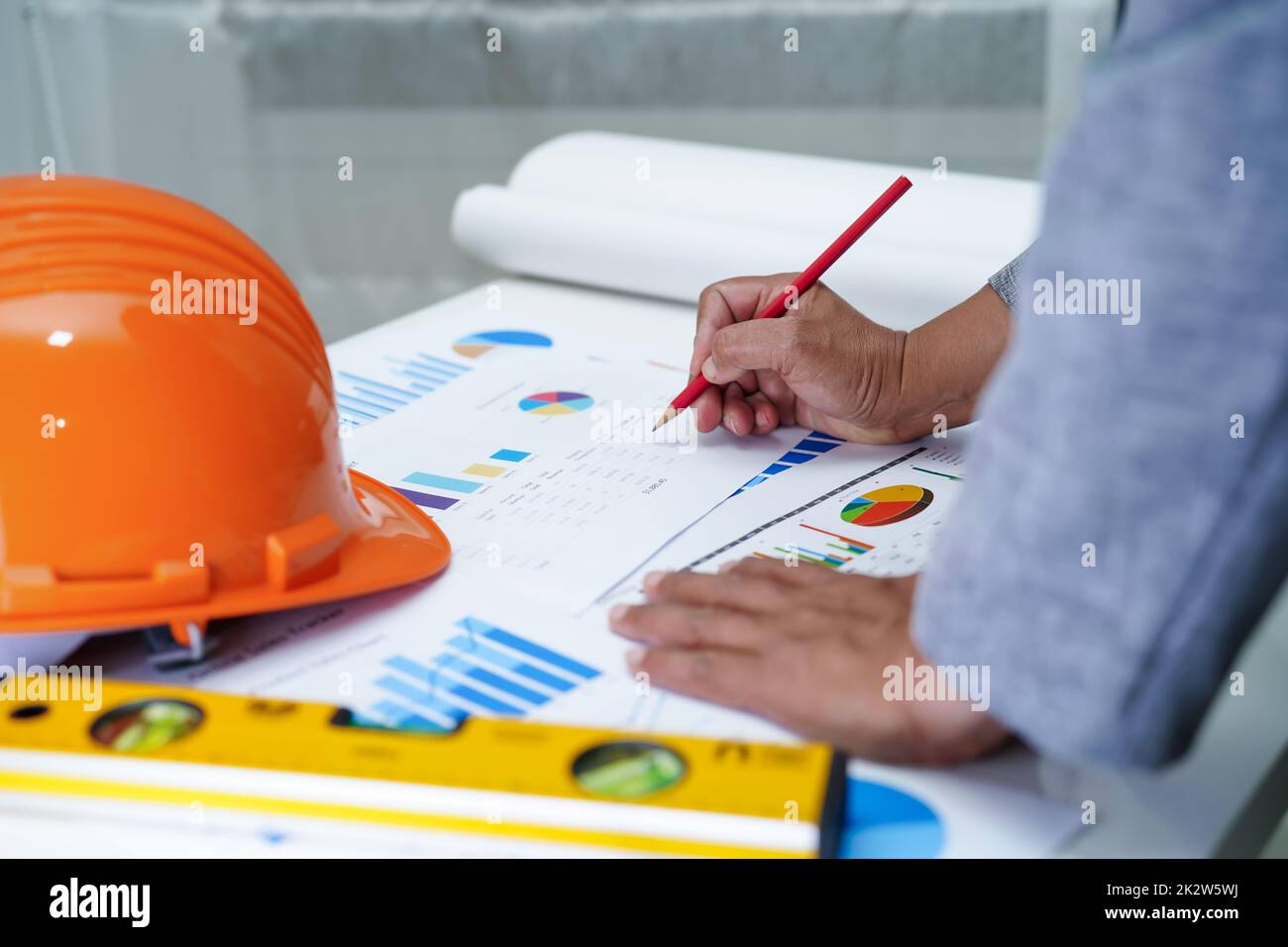 Architect or engineer working project accounting with graph and ...