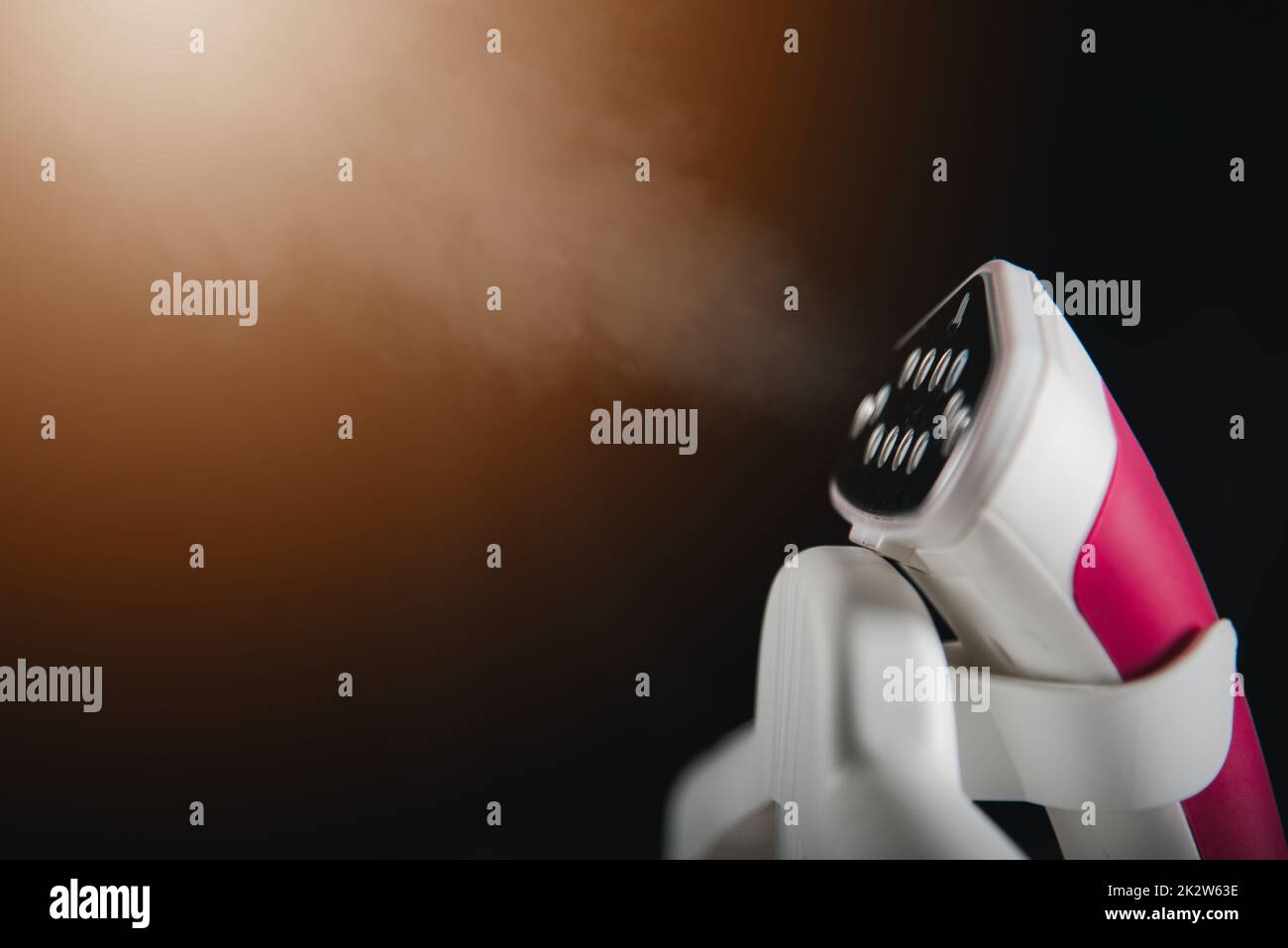 Close up of electric hand steam generator while it's hot and steam ...