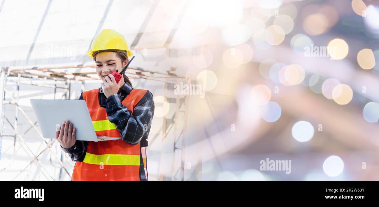Asian engineer architect worker woman working at build construction site use laptop and talking ...