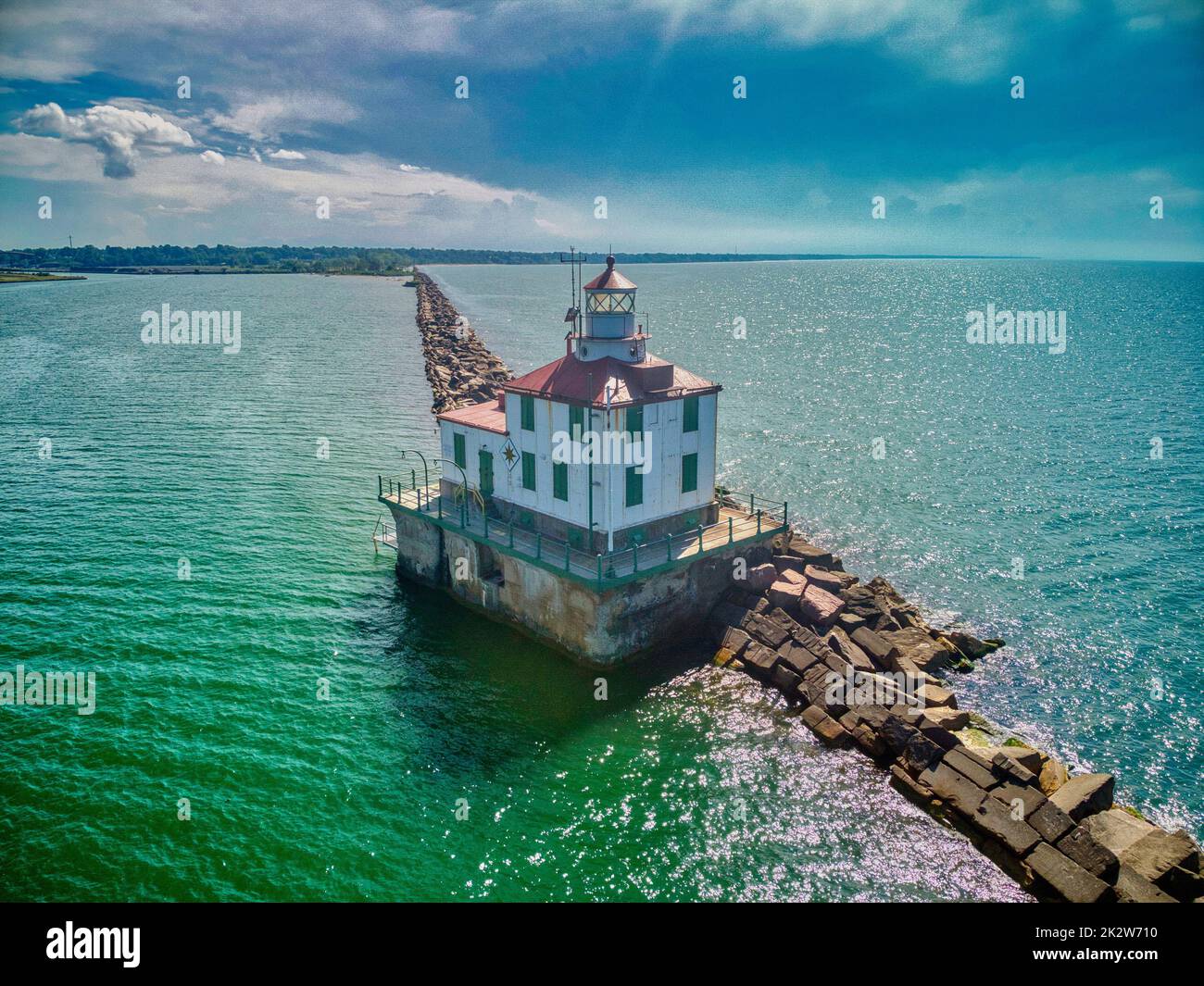 A drone shot of the Ashtabula Harbor Light building under a cloudy sky ...