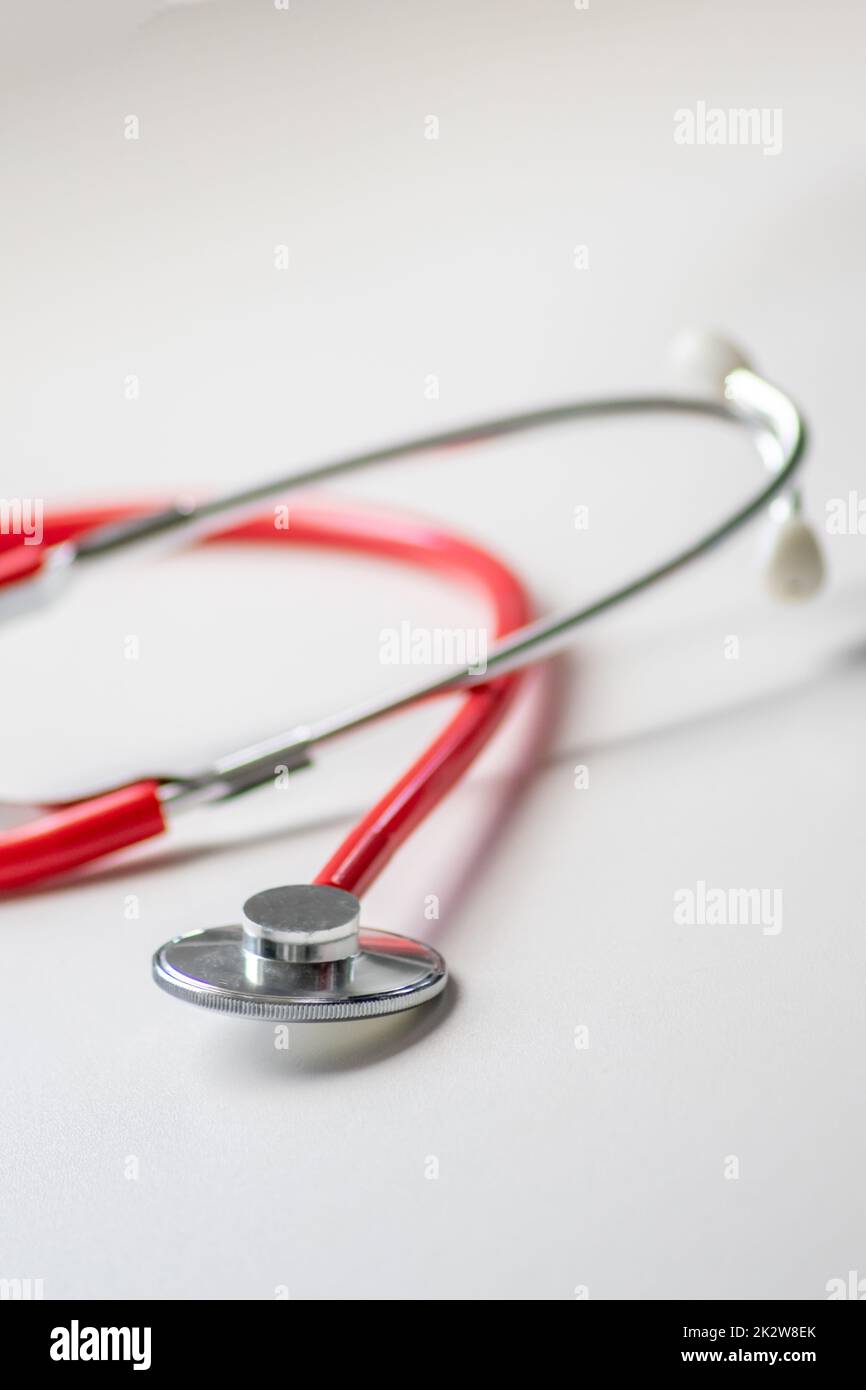 Red stethoscope in doctors office for professional cardio checkup and ...