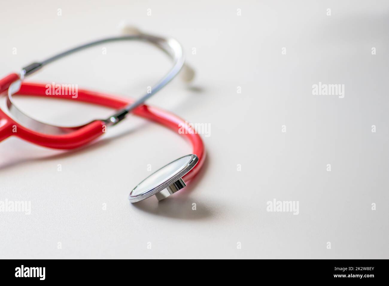 Red Stethoscope In Doctors Office For Professional Cardio Checkup And Healthy Heartbeat Pulse