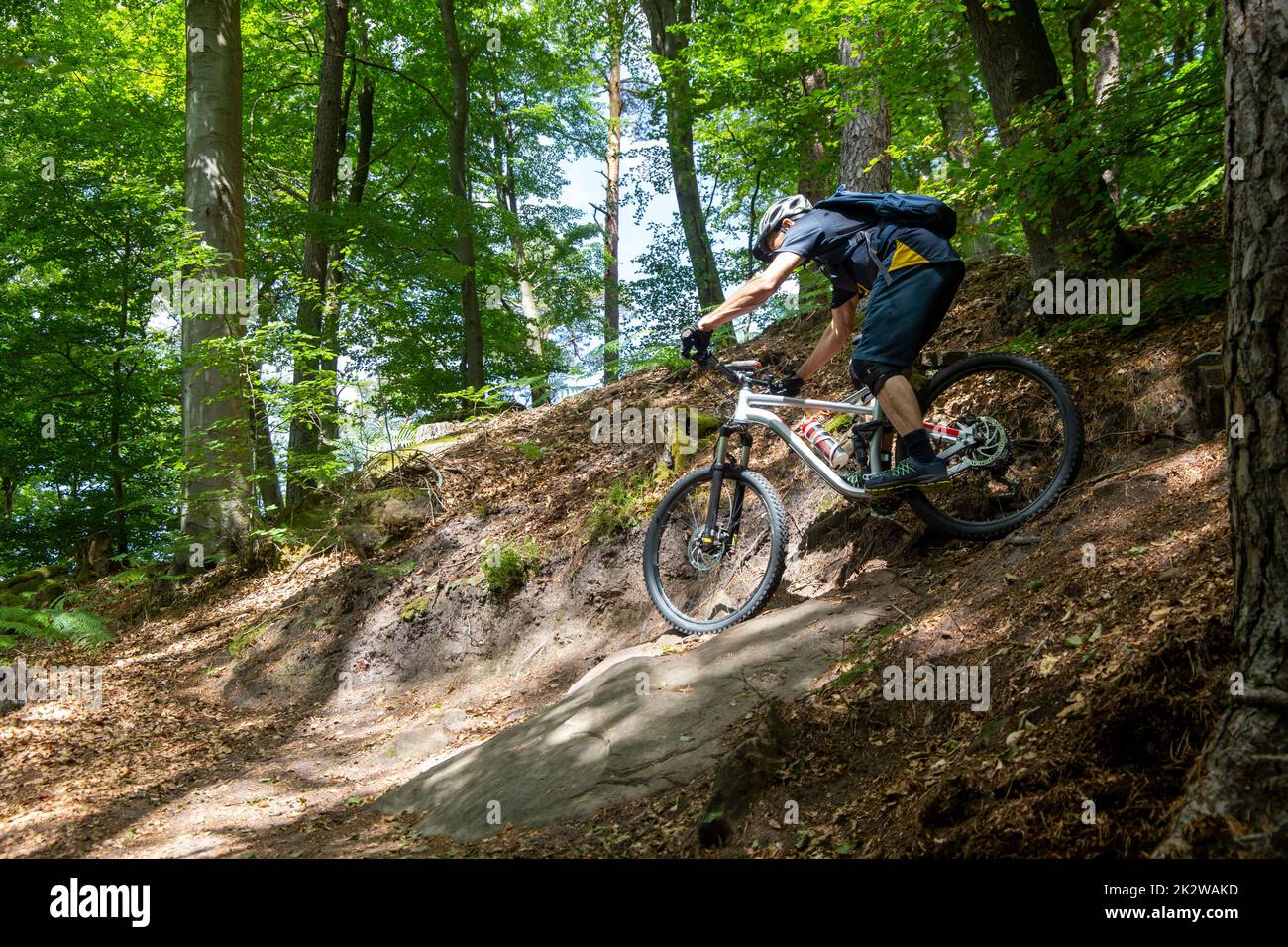 Mountain biker makes a tight switchback turn Stock Photo - Alamy