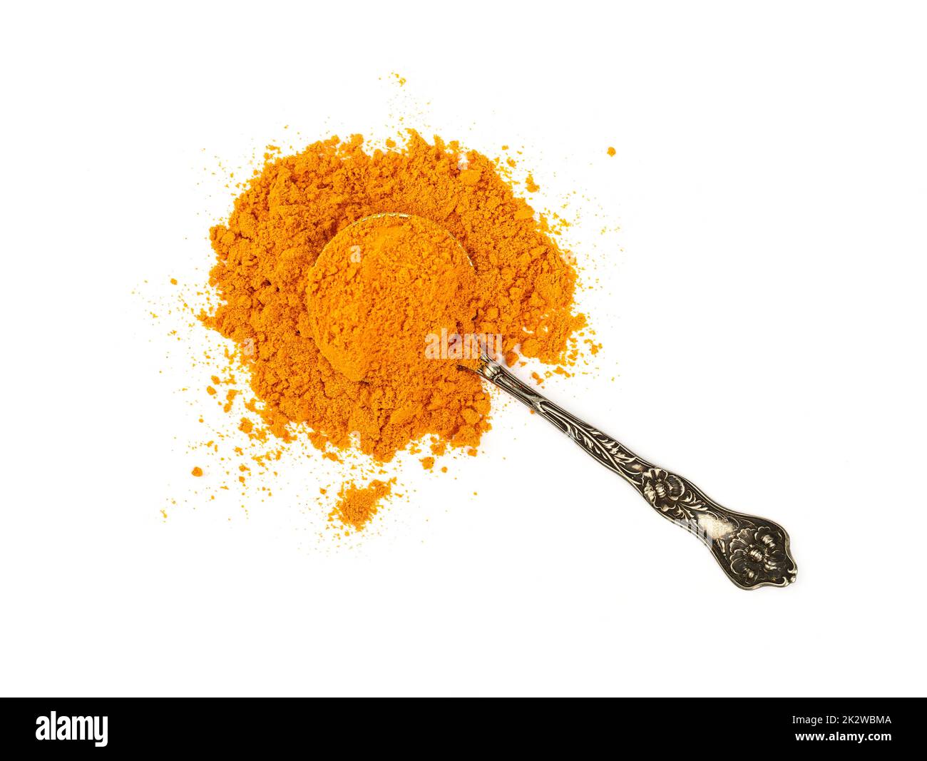 Close up one vintage metal spoon full of yellow turmeric spice powder ...