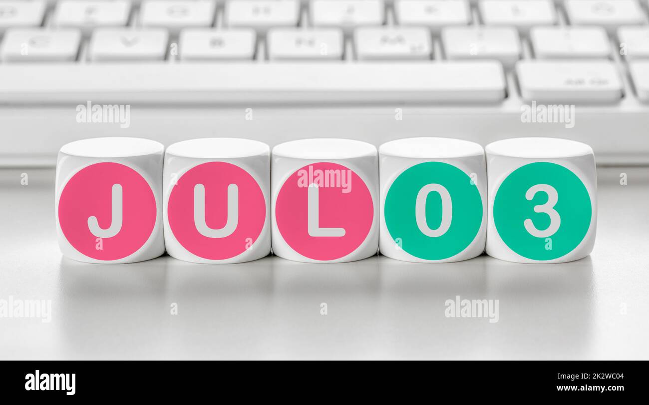 Letter dice in front of a keyboard - July 03 Stock Photo - Alamy