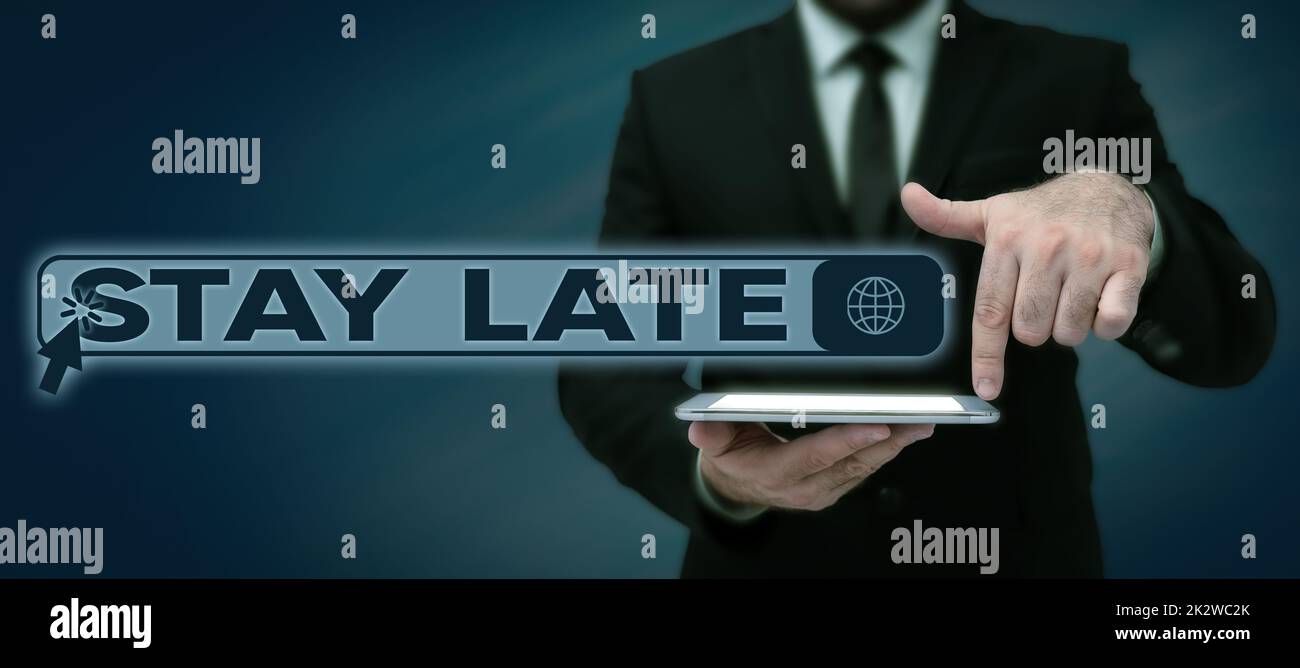 Text sign showing Stay Late. Concept meaning A routine in which a ...