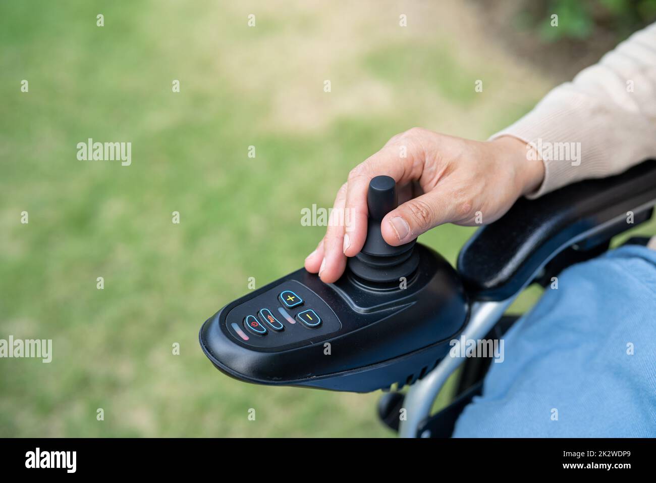 Asian lady woman patient on electric wheelchair with joystick and ...