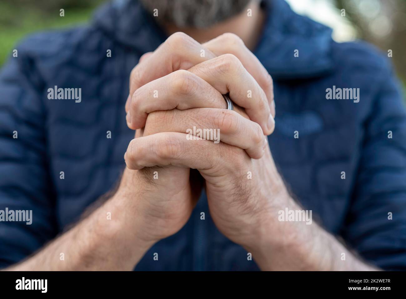 A closeup shot of two interlocked hands of a person praying Stock Photo ...