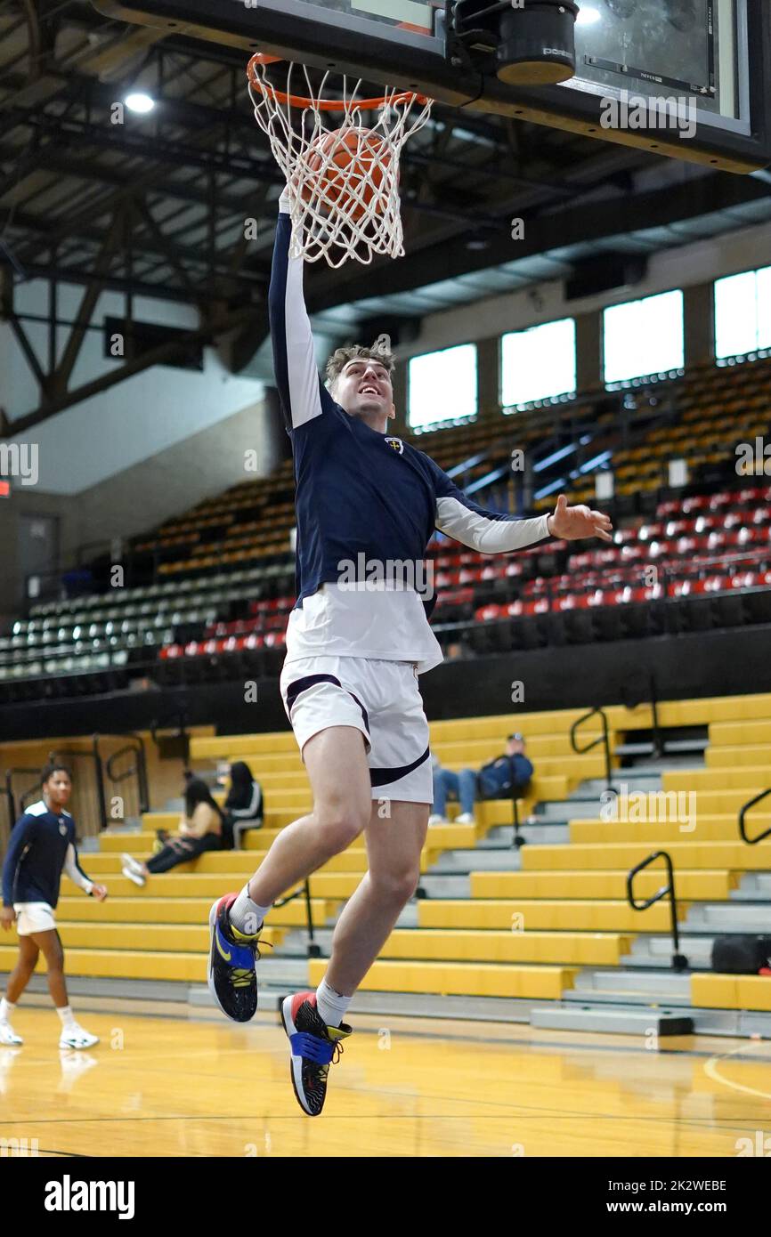 A vertical of a Caucasian guy playing basketball at Bosco vs United ...