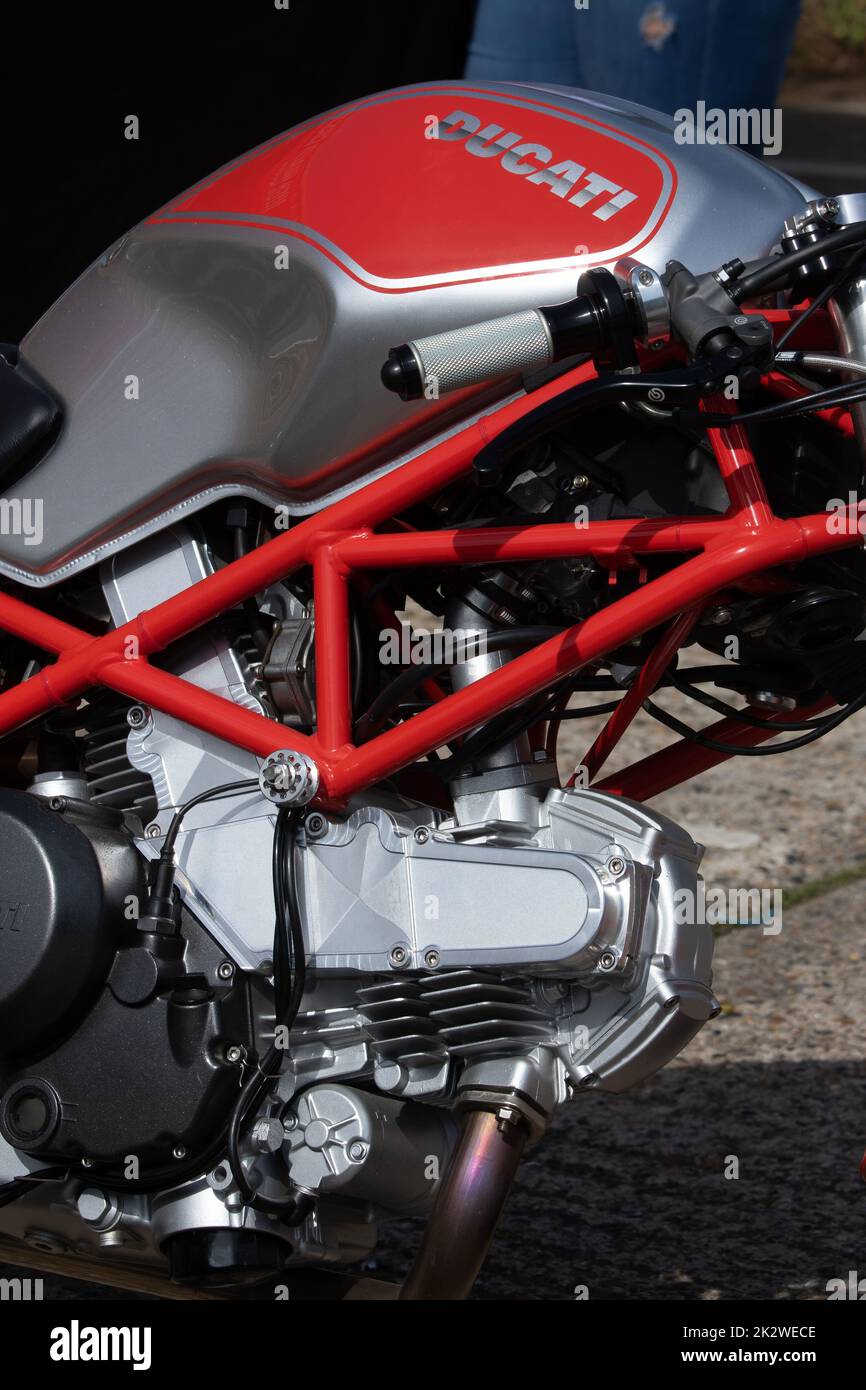 A vertical shot of a Ducati motorcycle engine closeup showing logo on ...