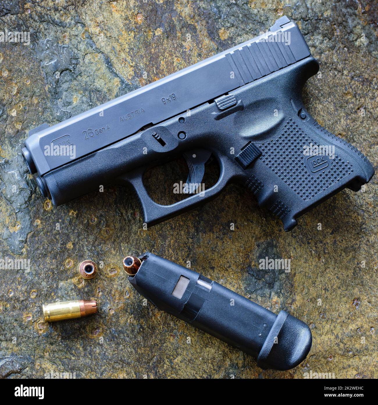 A top view of a black Glock 9mm pistol firearm handgun on a grungy ...