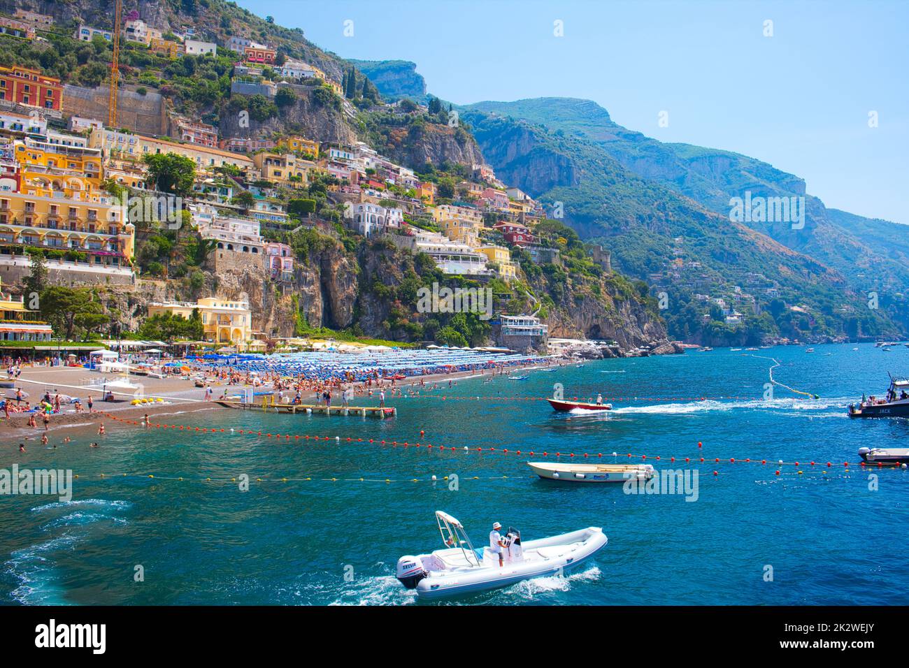 An aerial view of the shore of Positano with floating boats and ships ...