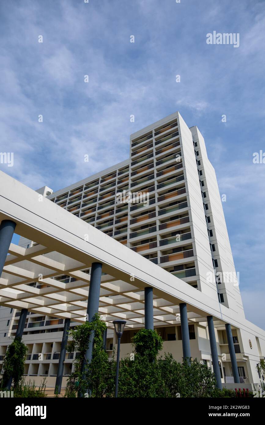 A vertical low-angle shot of a white building against the background of ...