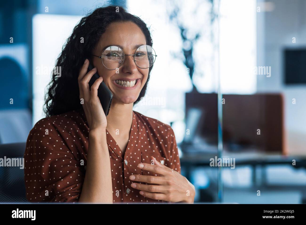 Young and beautiful hispanic woman talking on the phone and smiling ...