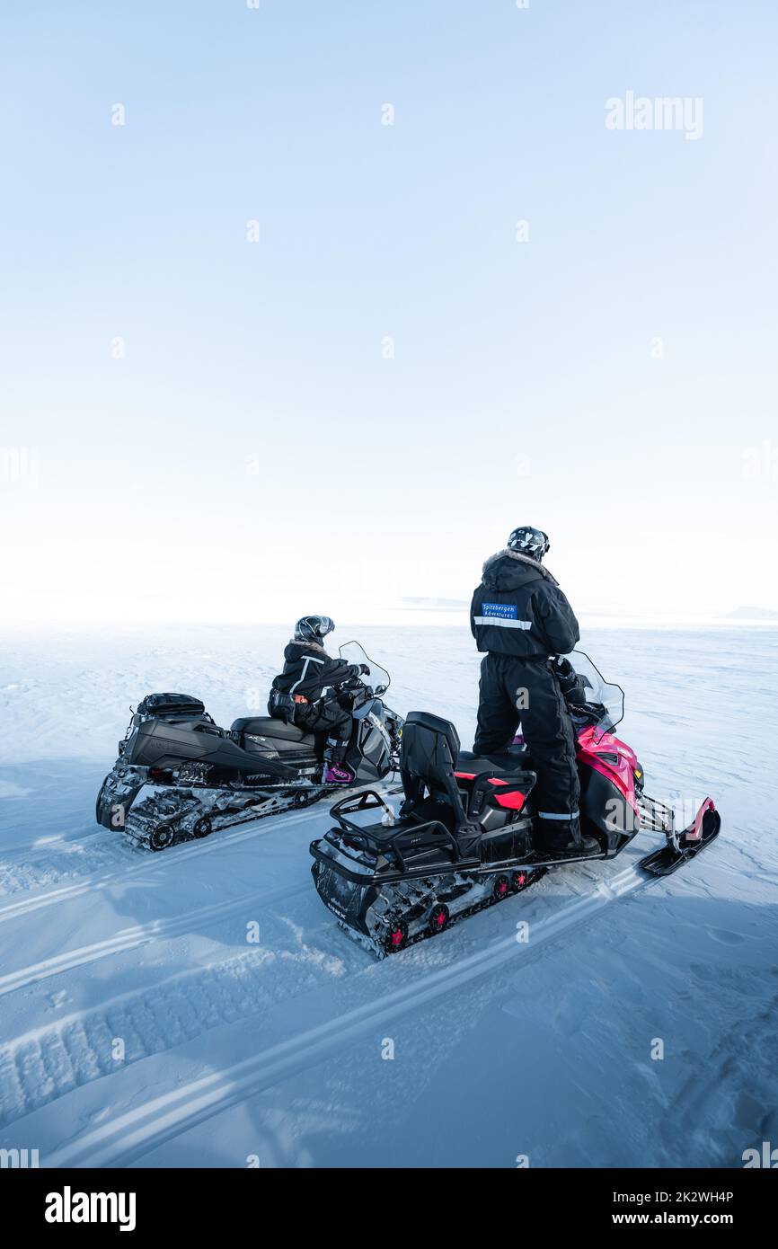 A vertical shot of snowmobile vacation trip of tourists in Longyearbyen ...